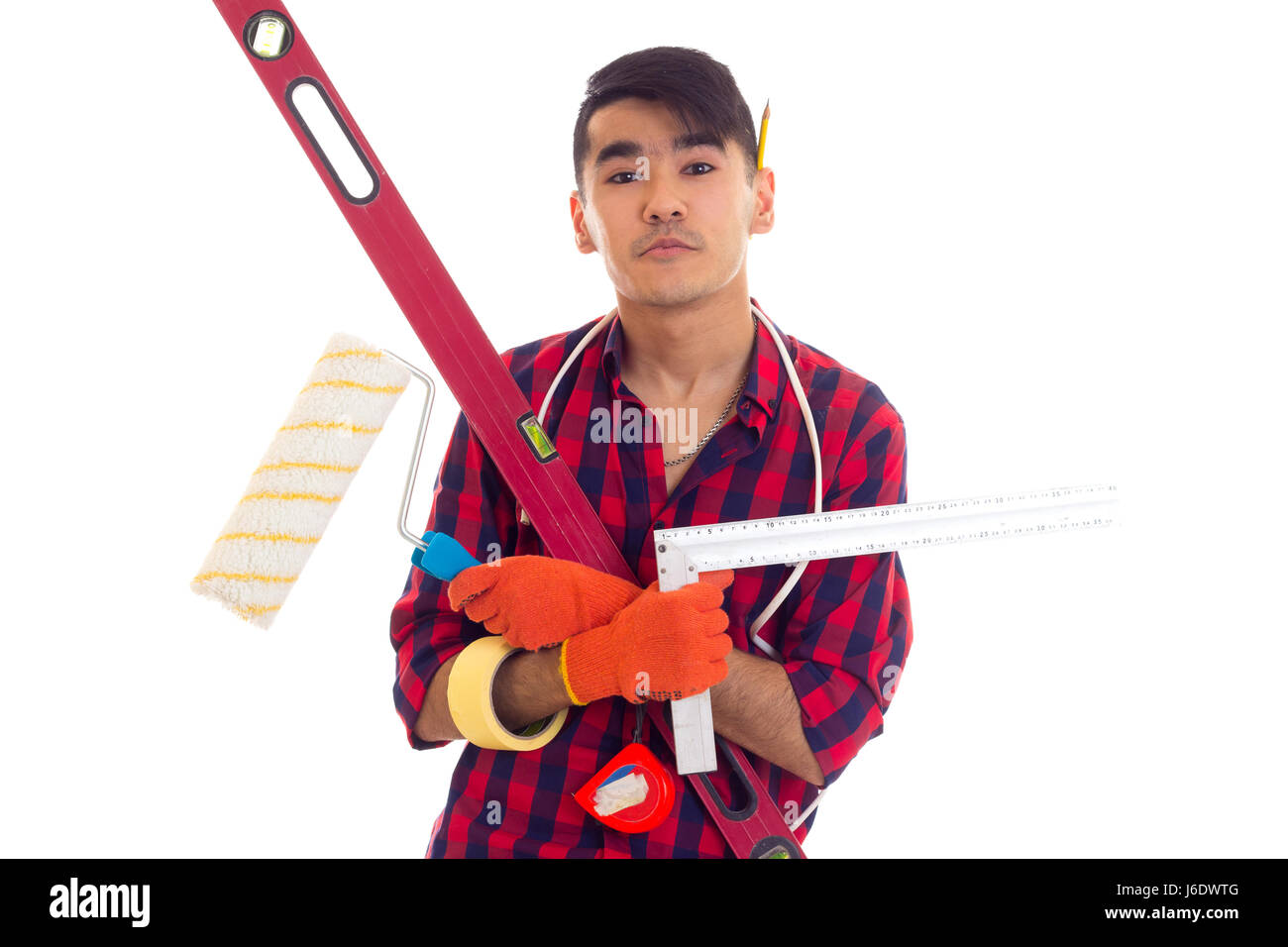 Young man in gloves holding level, roll and ruler Stock Photo - Alamy