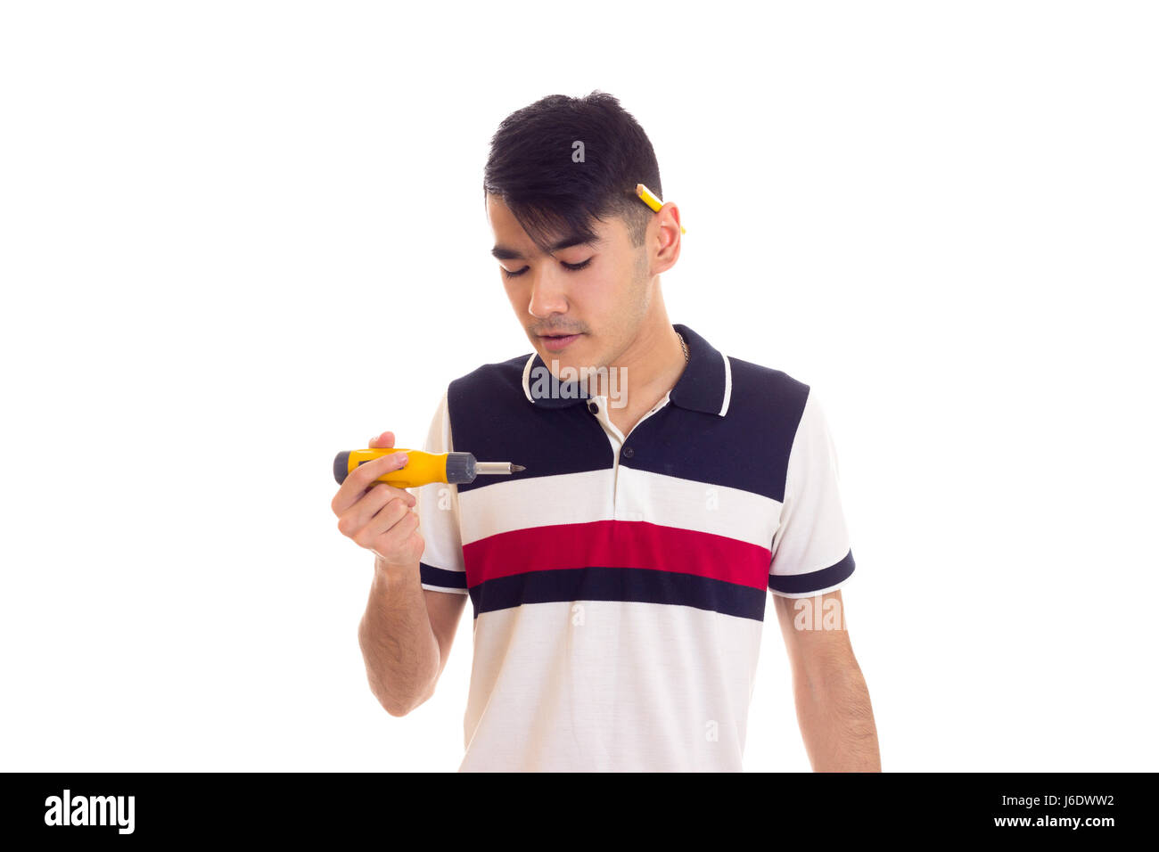 Young man holding a screwdriver Stock Photo - Alamy