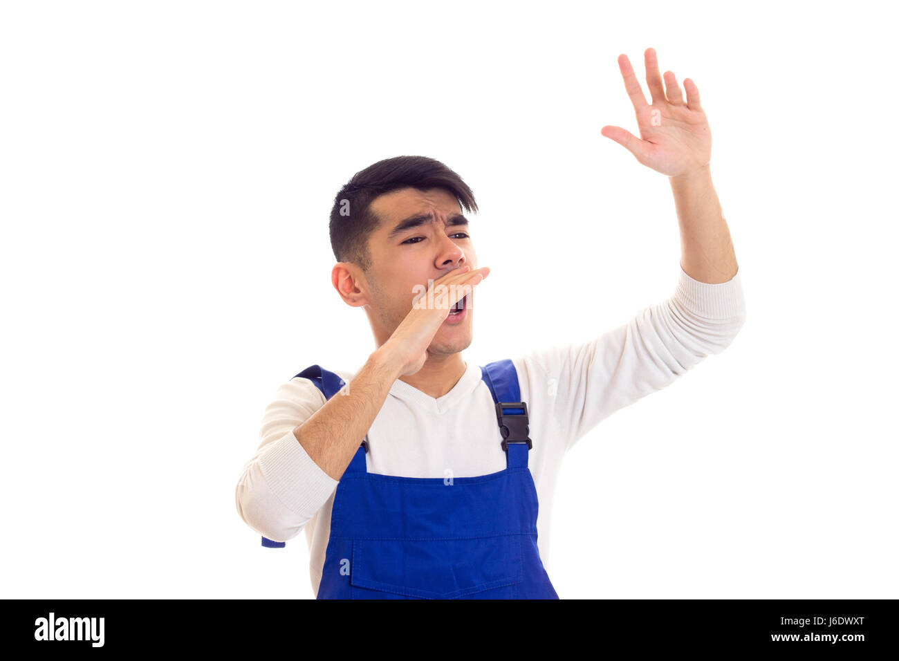 Young man in blue overall shouting Stock Photo - Alamy