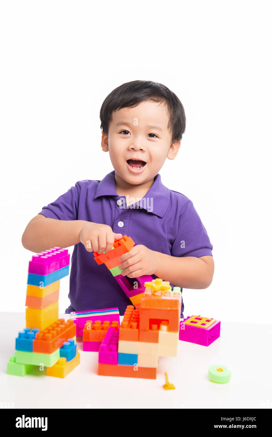 Kid boy playing with blocks from toy constructor isolated Stock Photo ...