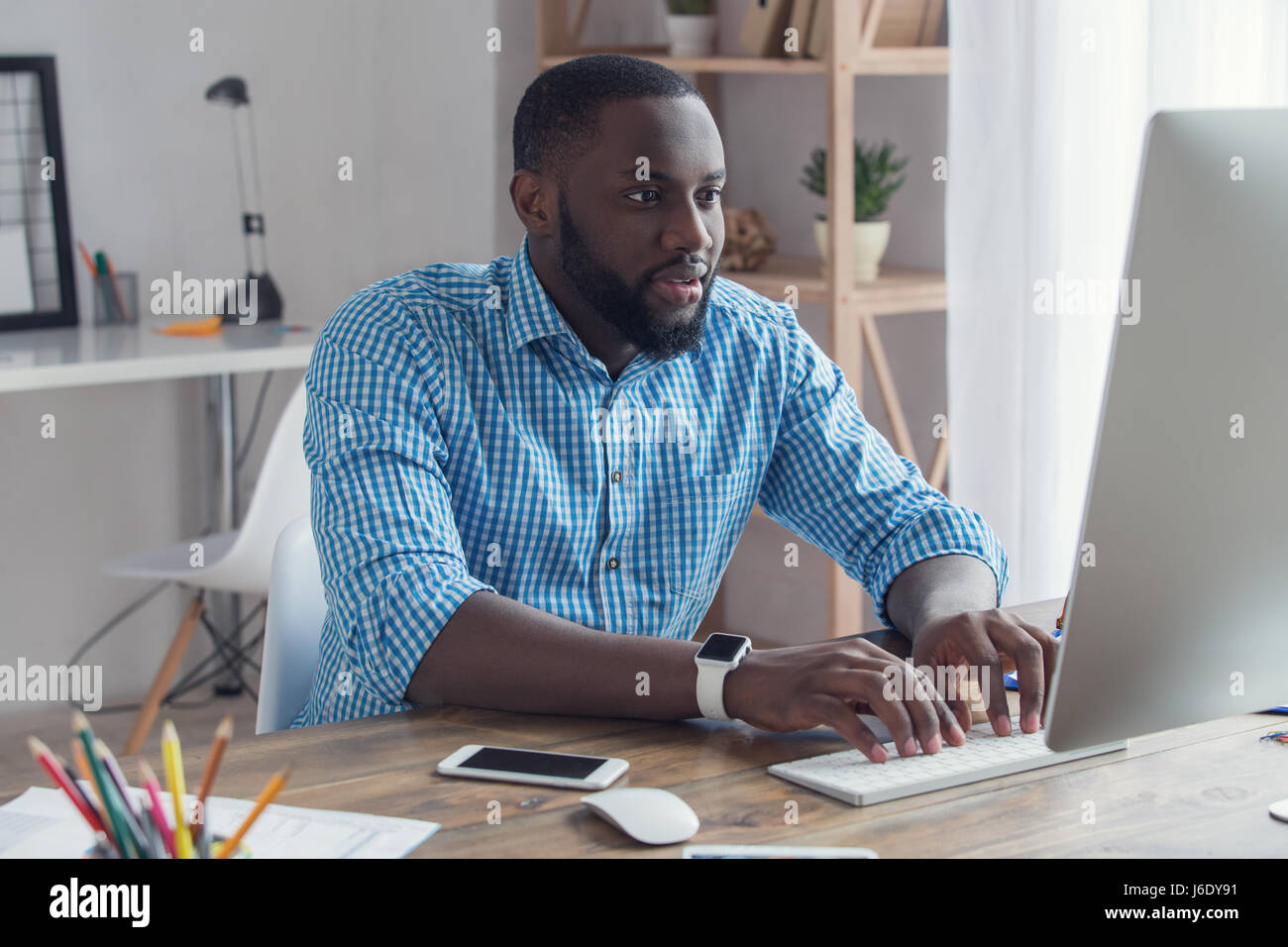 Young african man working in the office business Stock Photo - Alamy