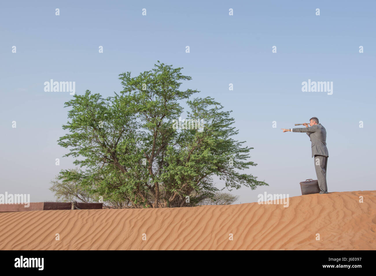 businessman discovers something in desert Stock Photo - Alamy