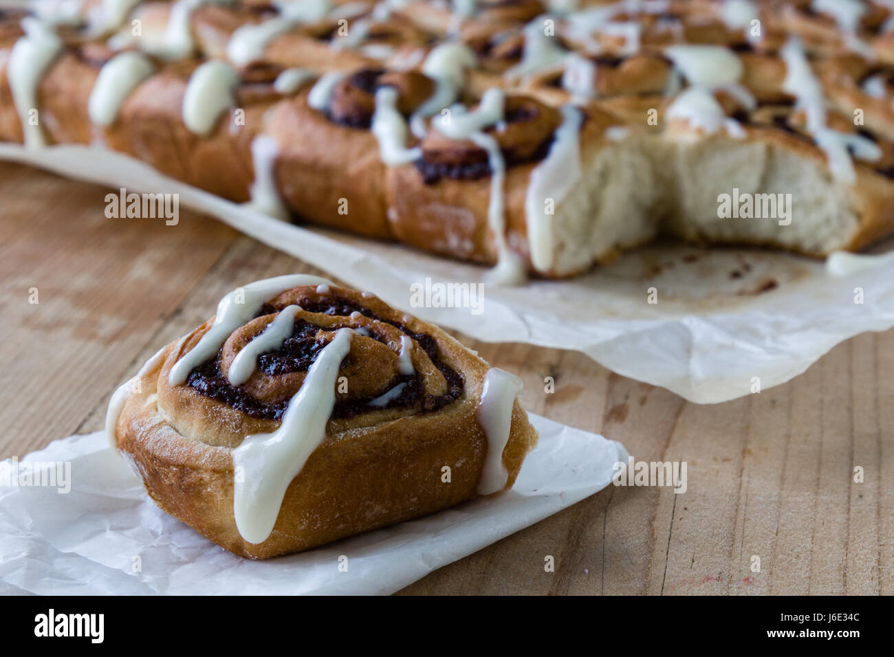 fresh baked brown homemade cinnamon rolls with icing Stock Photo - Alamy