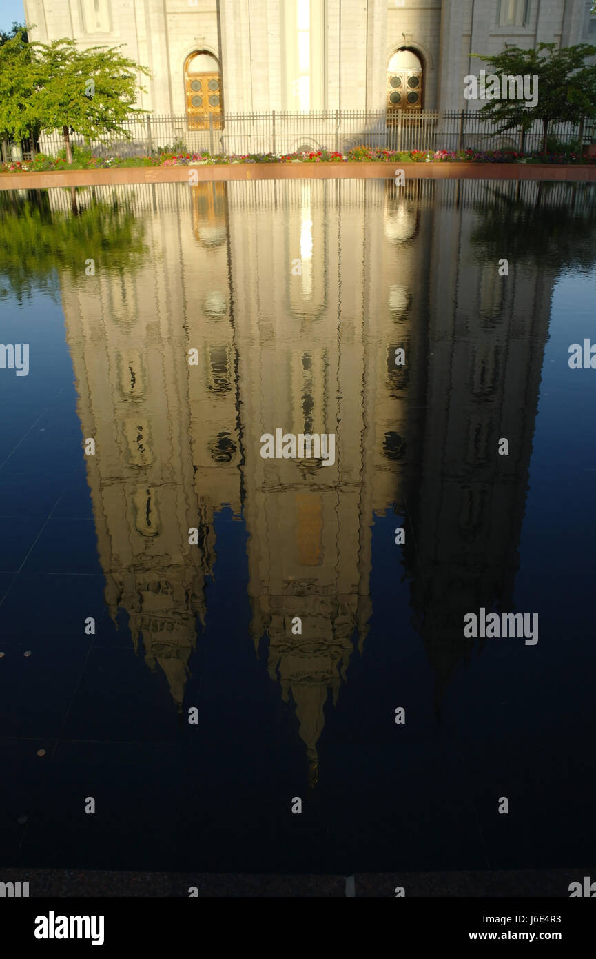 Sunny portrait east facade Salt Lake Temple reflecting in lake water ...