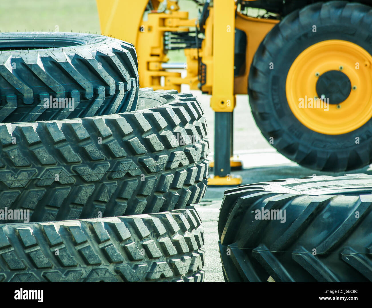 Huge wheels for agricultural machines are stacked on a ground. A part ...