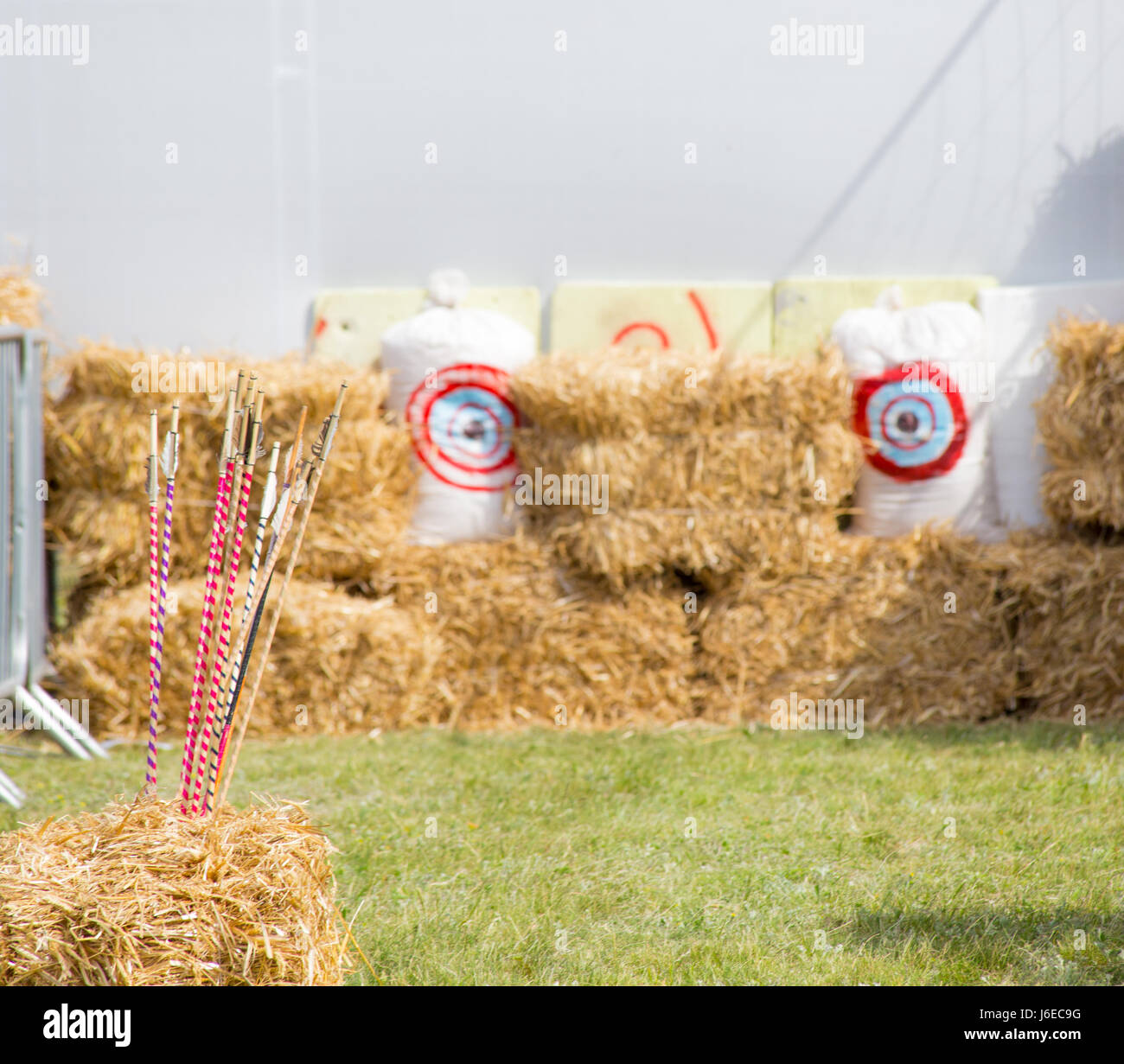 Archery targets and differernt colored arrows on rural shooting range ...