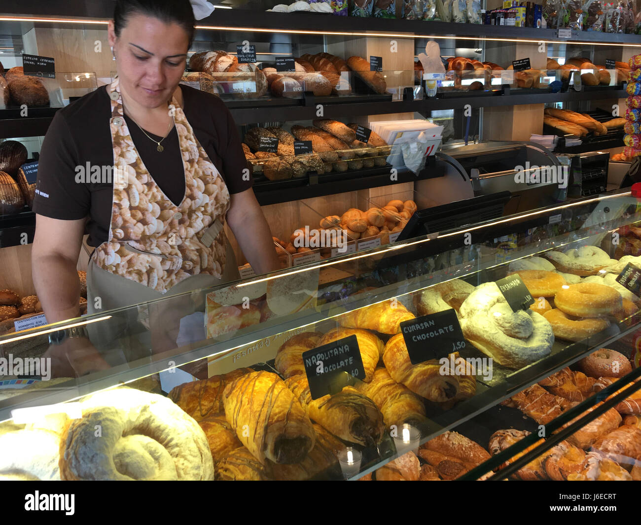 Cafe Wien interior, assistant and display of pastries at the counter ...