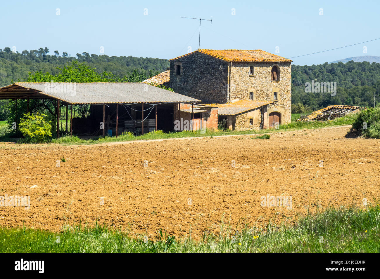 A rustic farm building by a fallow field Stock Photo - Alamy
