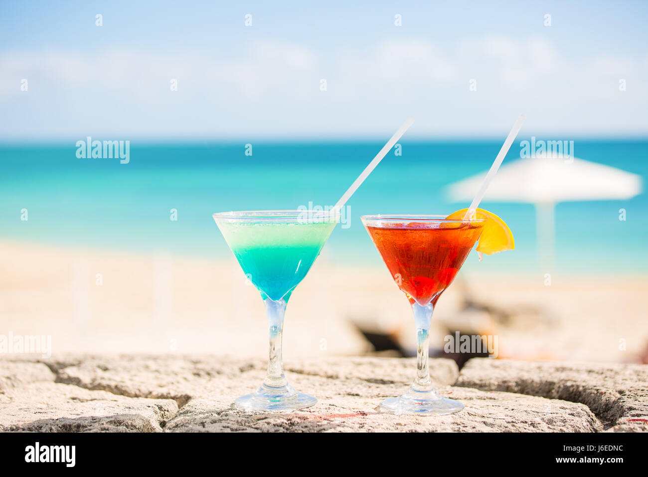 Two tropical cocktails on tropical beach ocean white sand and seascape ...