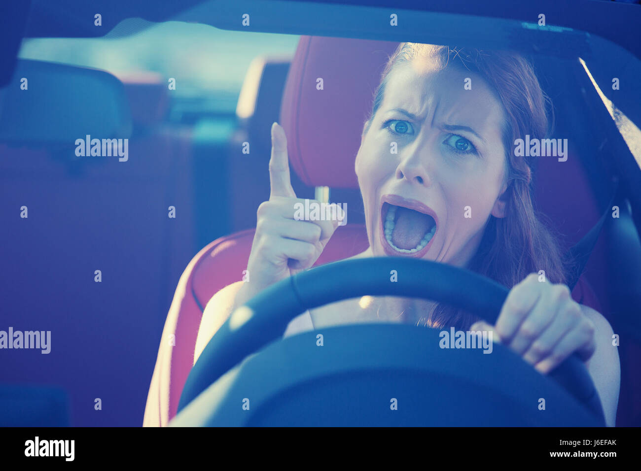 Portrait displeased angry pissed off aggressive woman driving car ...