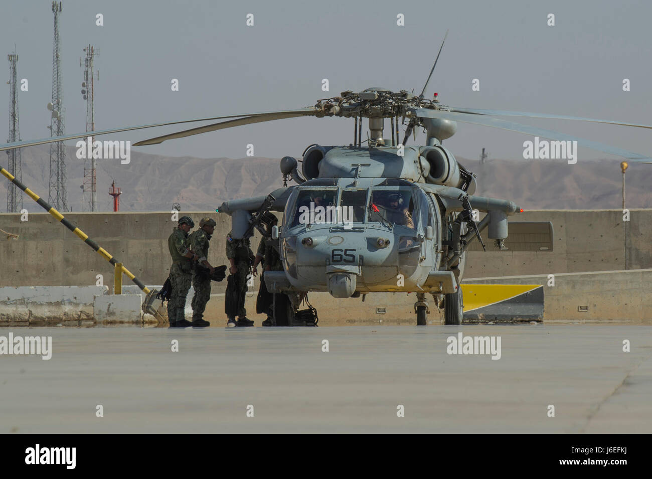 Members of Commander, Task Group 56.1, EOD Mobile Unit 12, prepare to ...