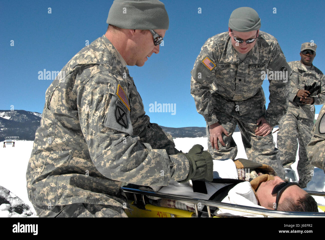 Members of the Colorado Army National Guard’s Snow Response Team load a ...