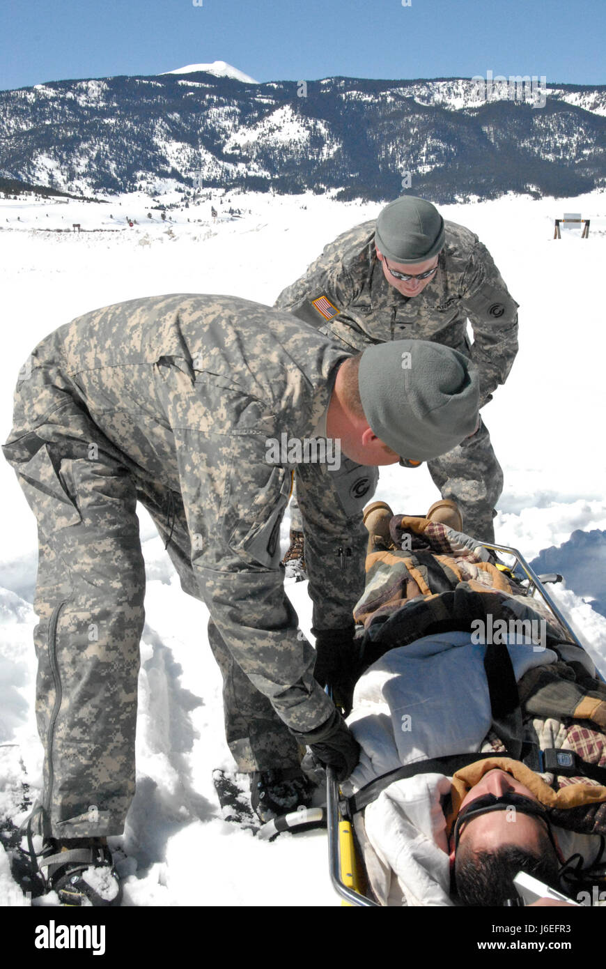 Members of the Colorado Army National Guard’s Snow Response Team load a ...