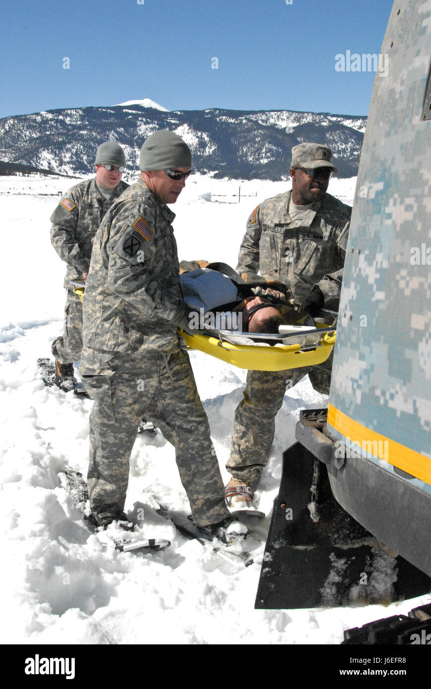 Members of the Colorado Army National Guard’s Snow Response Team load a ...