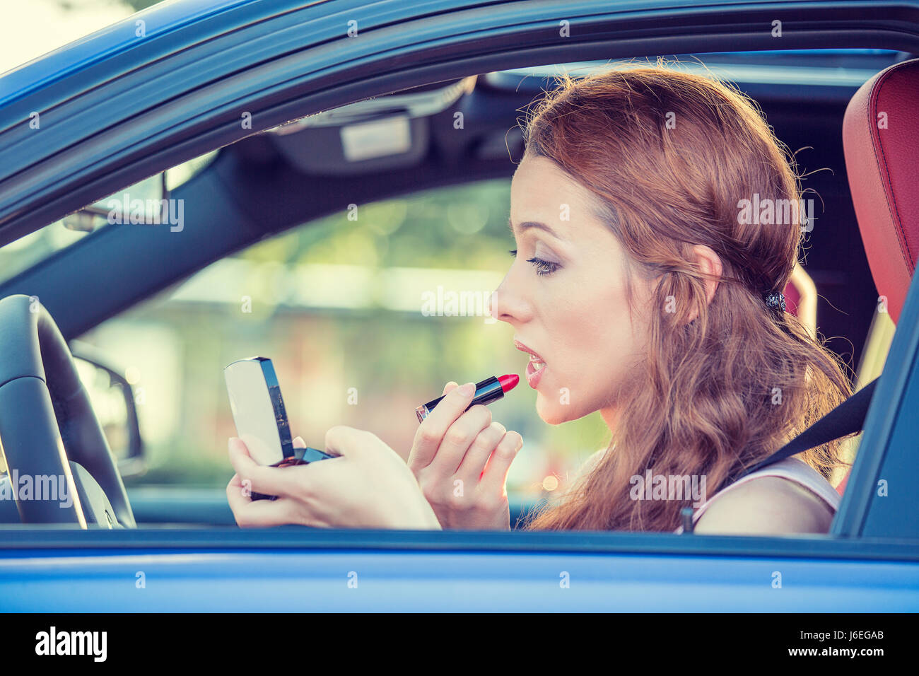 Teenager girl applying lipstick hi-res stock photography and images - Alamy