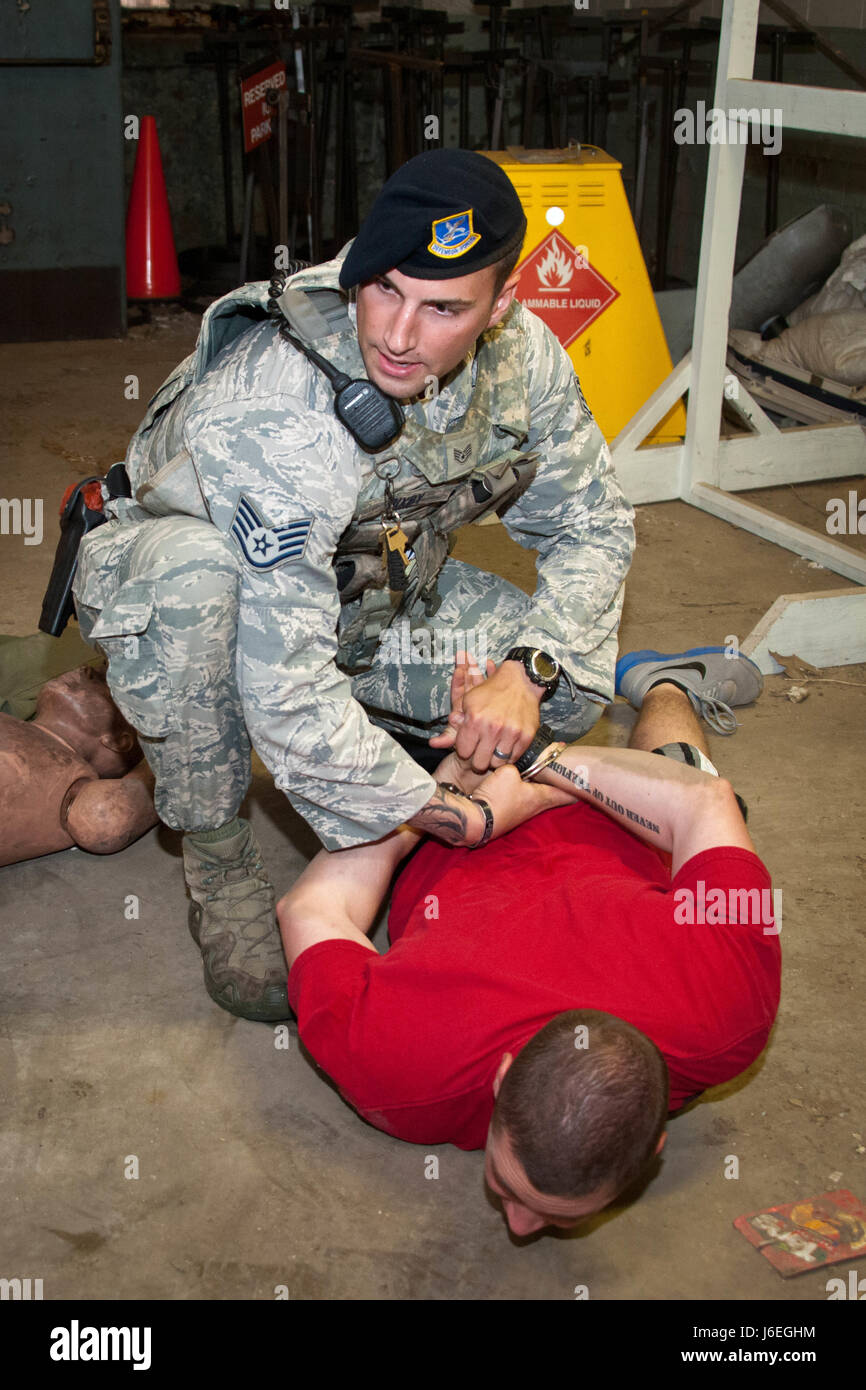Staff Sgt. Brandon Bixby, 42nd Security Forces member, simulates ...