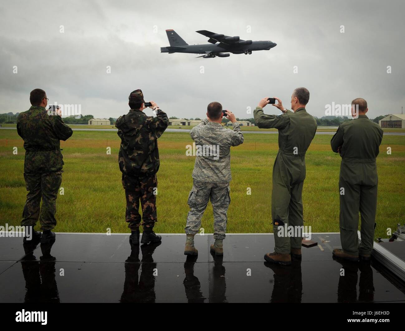 Defense attaché members photograph a B-52H Stratofortress take off from ...