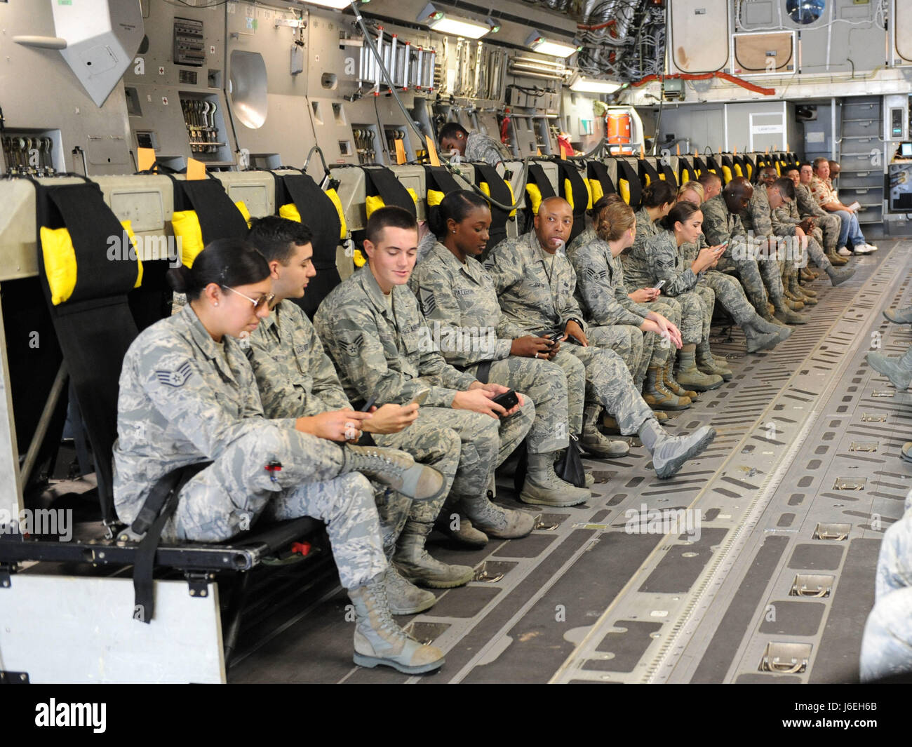 Personnel board a C-17 Globemaster III during a hurricane evacuation ...