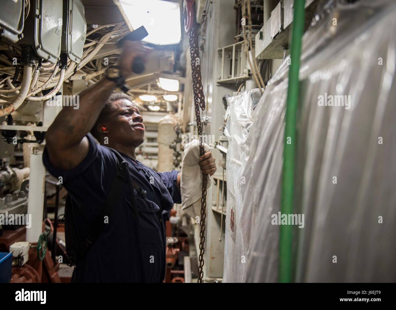 A Gas Turbine System Technician aboard USS Stout (DDG 55) performs ...