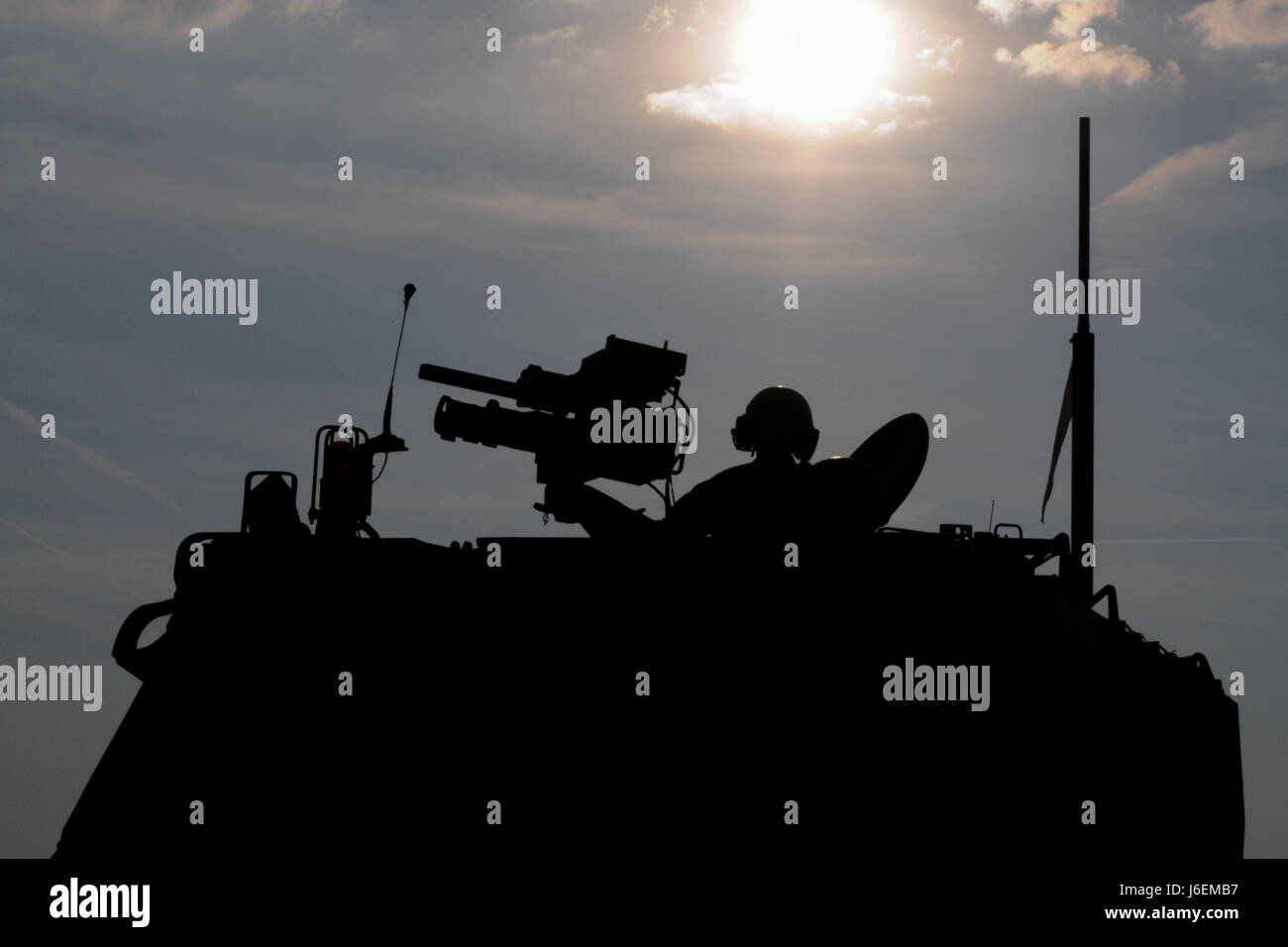 A Montenegrin Soldier stands watch in an M-113 armored personnel ...