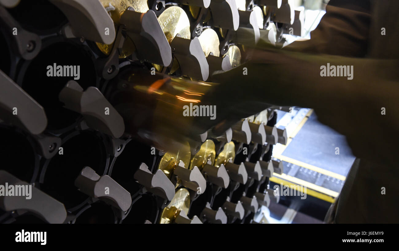 A 105 mm shell is loaded into a storage rack on an AC-130J Ghostrider ...