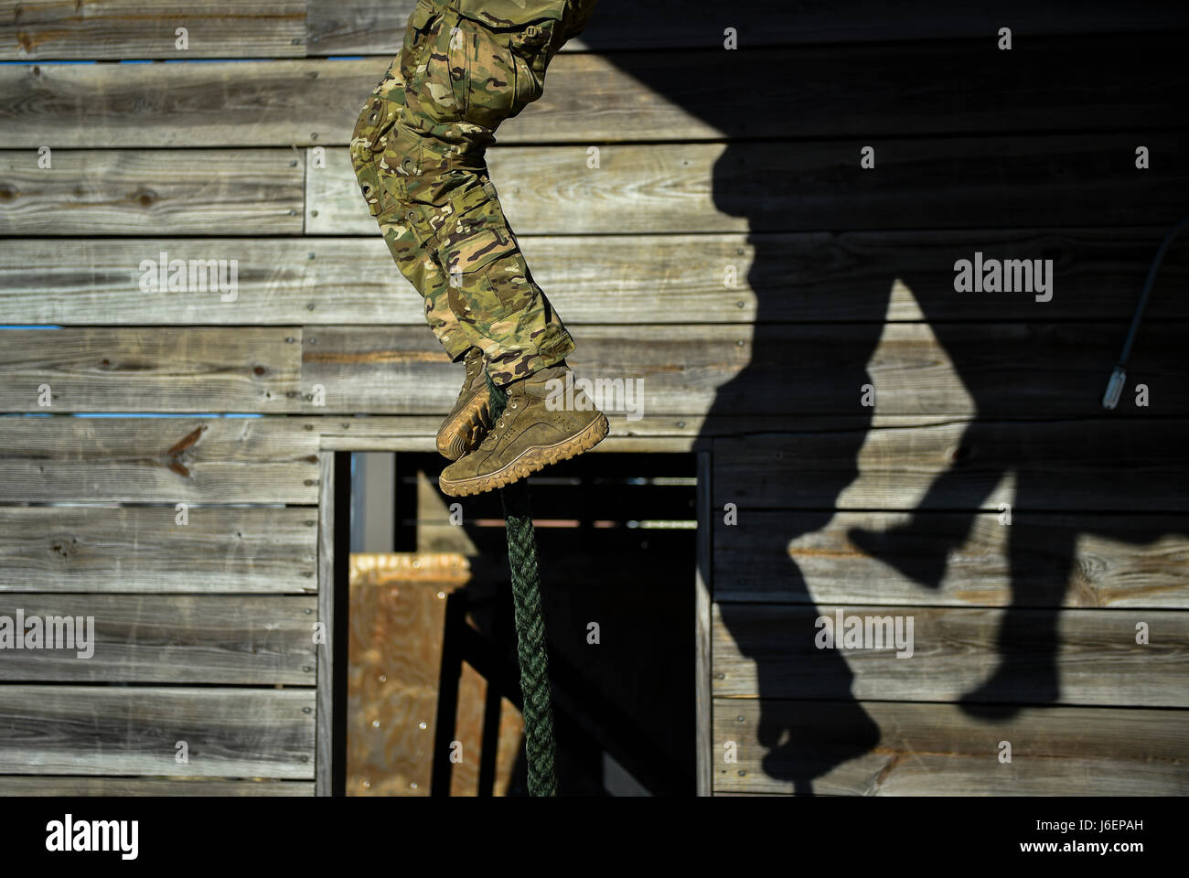 A Soldier with the 1st Battalion, 10th Special Forces Group, fast ropes ...