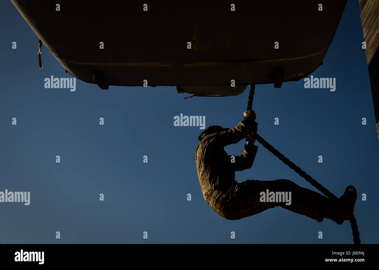 A Soldier with the 1st Battalion, 10th Special Forces Group, fast ropes ...