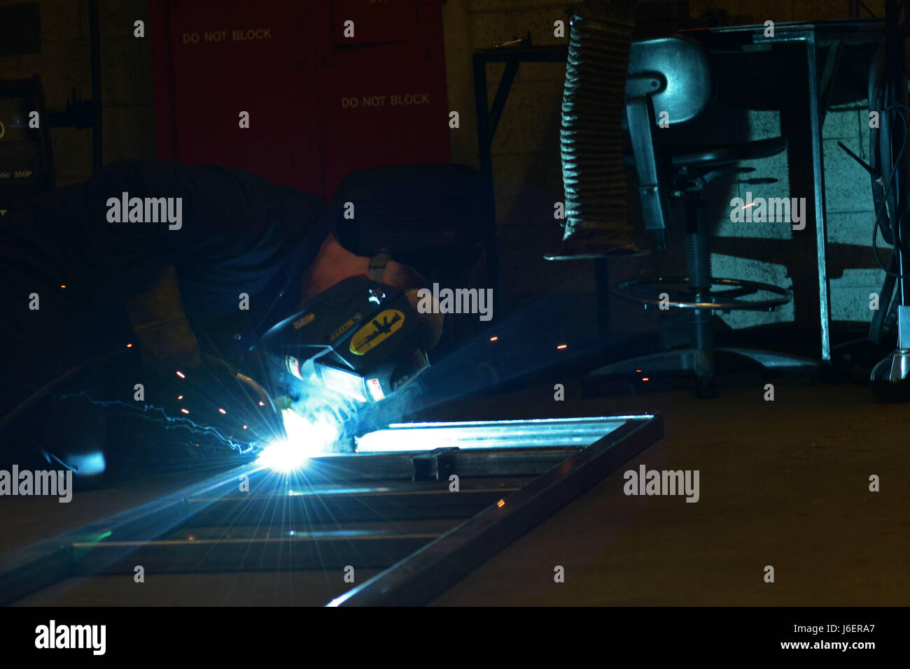 Air Force metals technology personnel weld a metal hazard sign post at ...