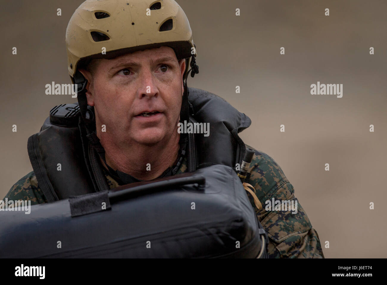 Lt. Col. Kevin R. Root recovers his gear after scout swim to the shores ...