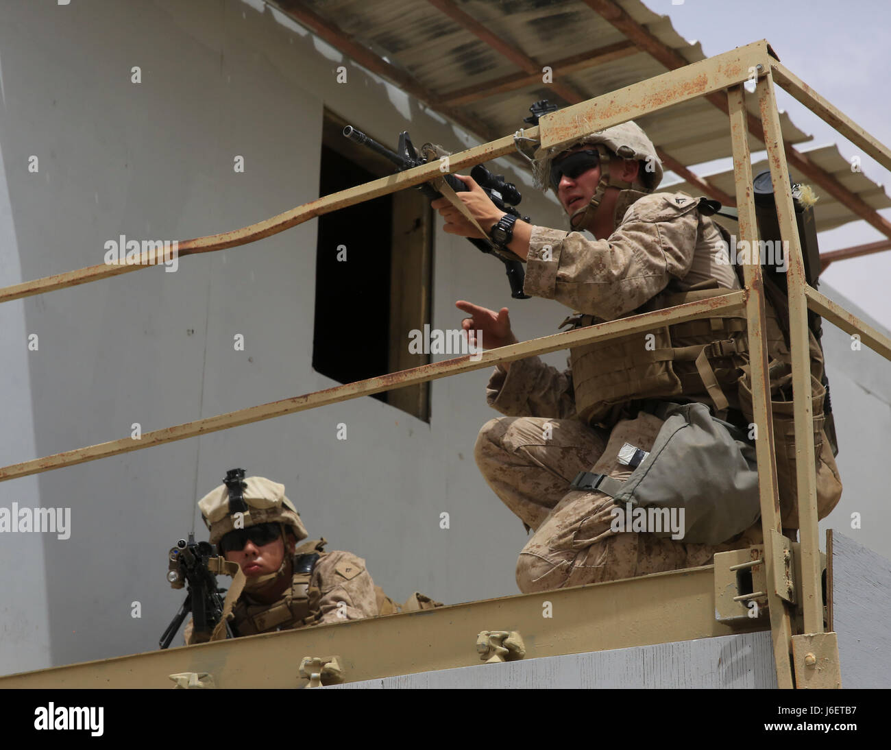 U.S. Marine Corps Lance Cpl. Ricardo Barrera and Cpl. James Montavon, riflemen with Baker ...