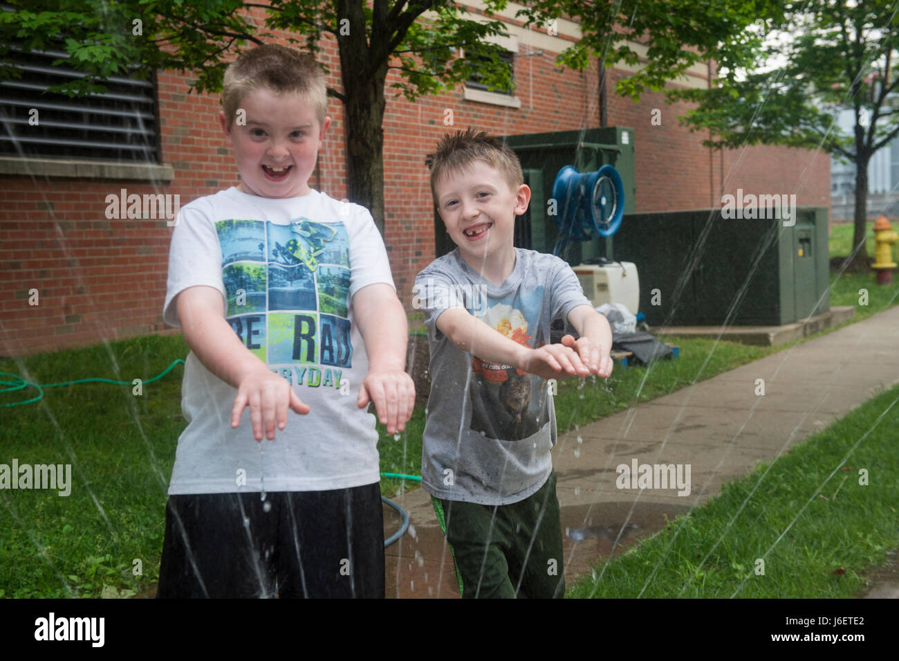Children play in the sprinklers during the Quantico 100 held at Butler ...