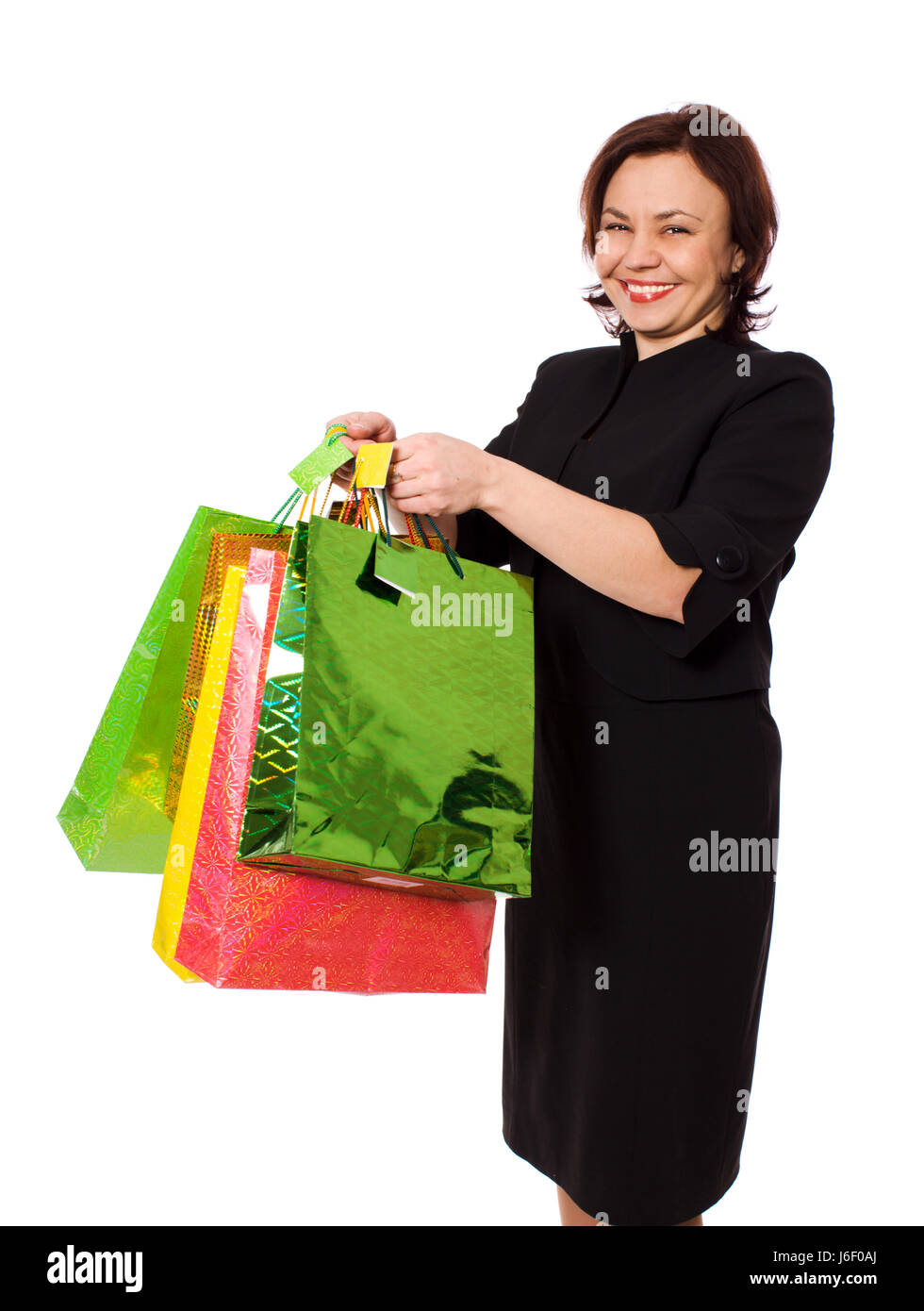Happy senior woman stretching out hands with shopping bags and smiling ...