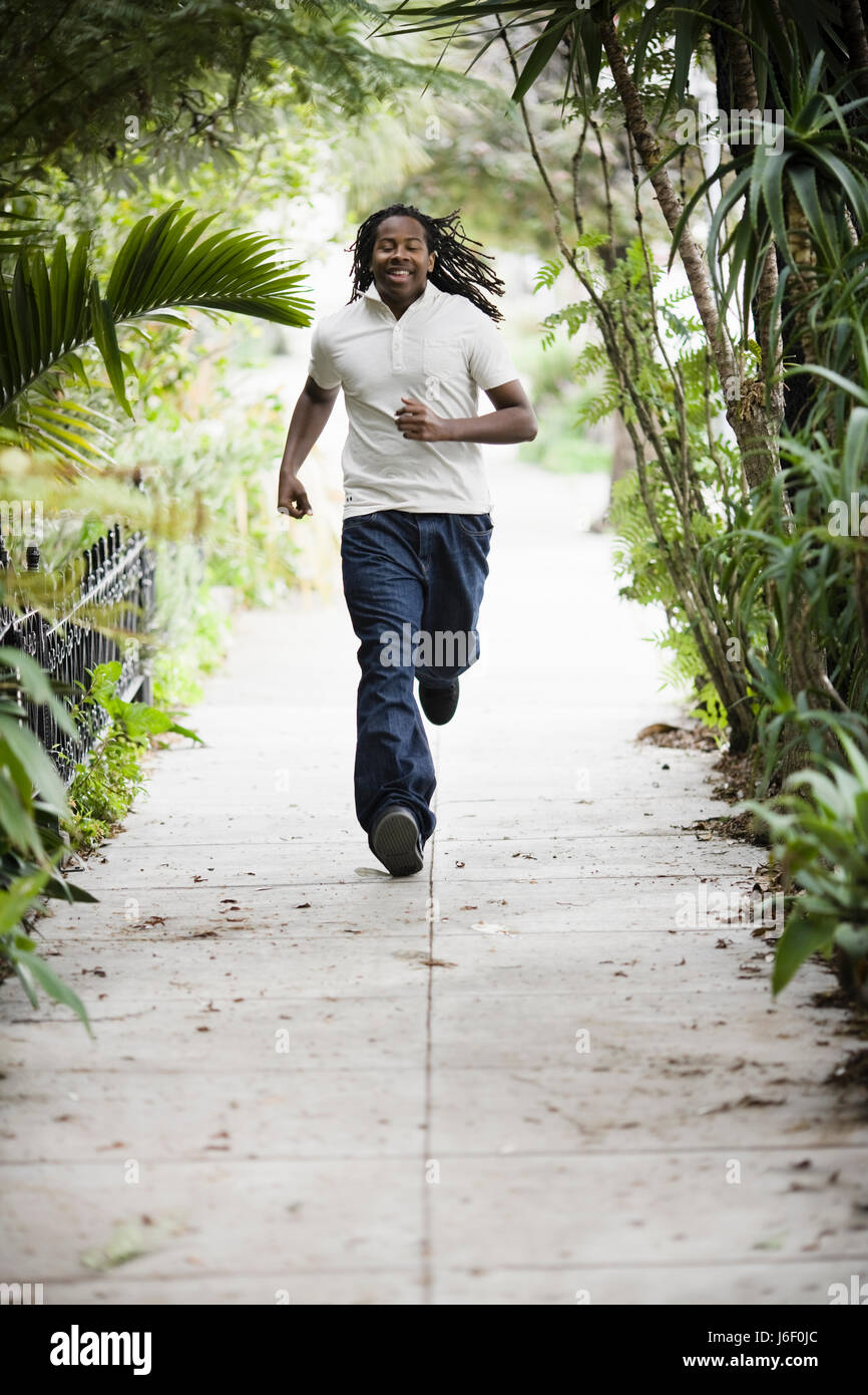 sidewalk sport sports run running runs boy lad male youngster humans ...