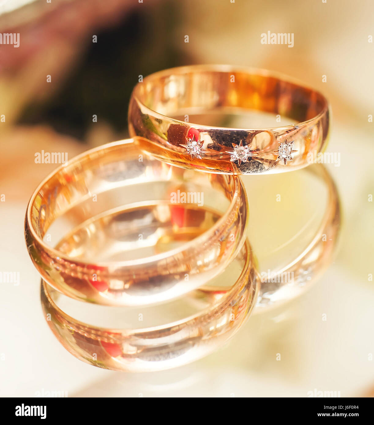 Two Golden Wedding Rings with diamond macro shot Stock Photo - Alamy