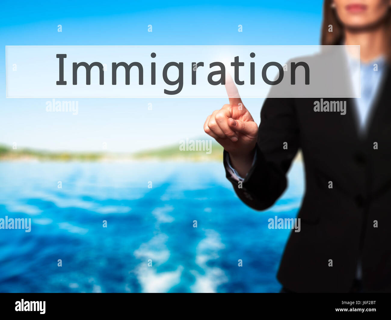 Immigration - Businesswoman hand pressing button on touch screen interface. Business, technology ...