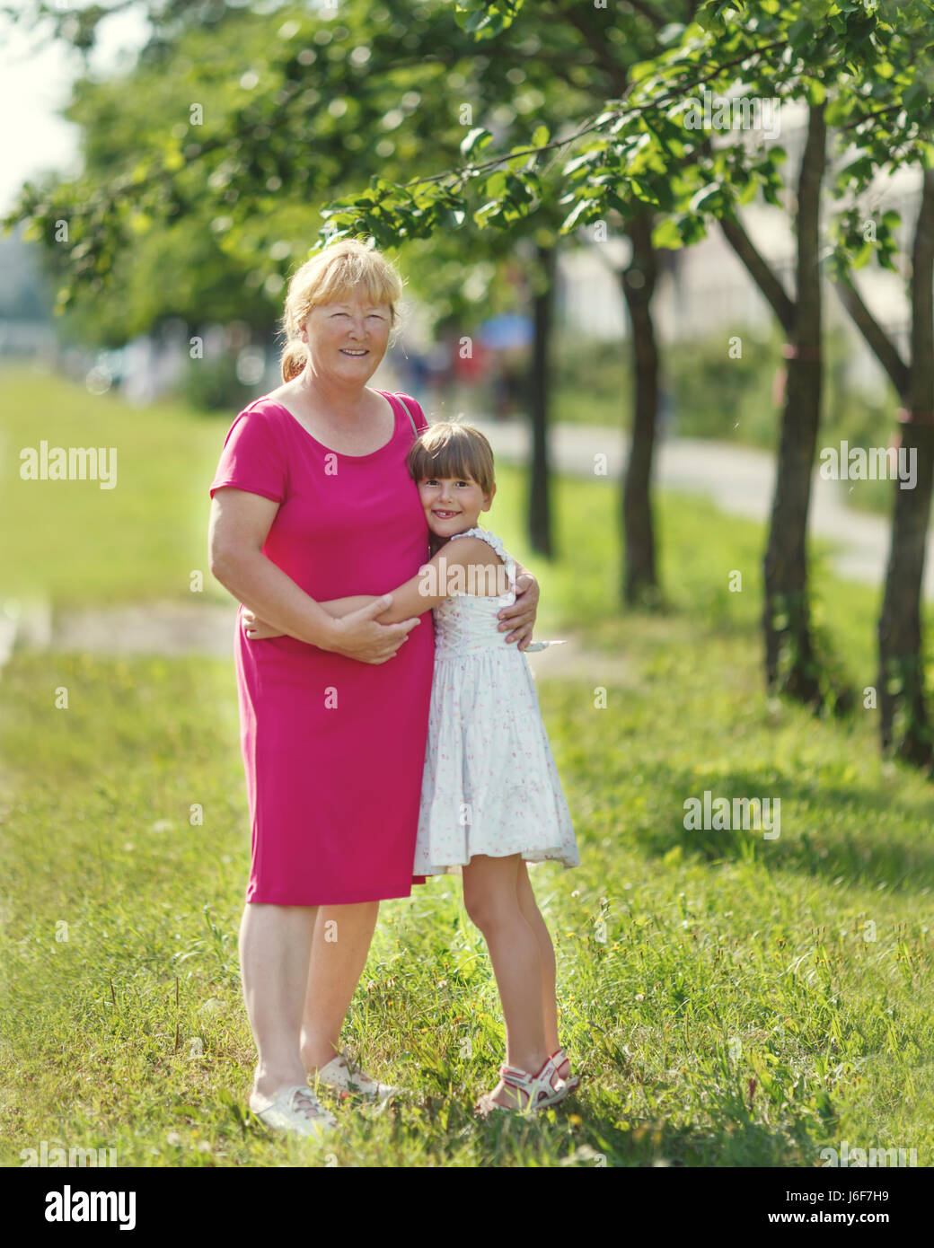 Grandmother with child hug together in summer streets Stock Photo - Alamy