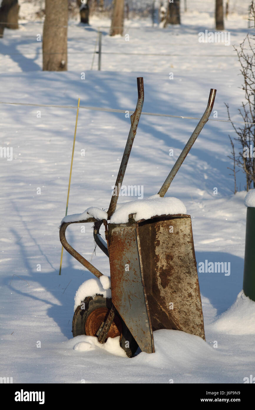 wheelbarrow in the snow Stock Photo - Alamy