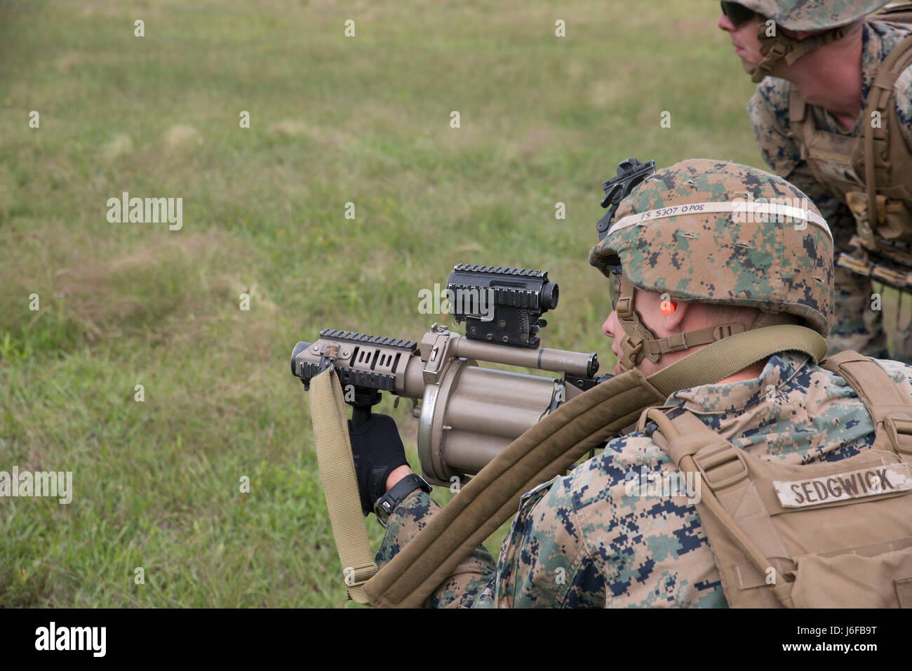 Marine Pfc. Jonathan Sedgwick aims an M32 multiple grenade launcher ...