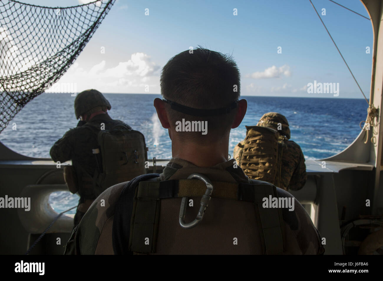 A French Commando Marine observes U.S. Marine's marksmanship skills ...
