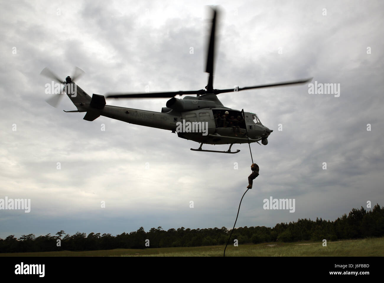 A Marine fast-ropes from a UH-1Y Venom helicopter during a fast-rope ...