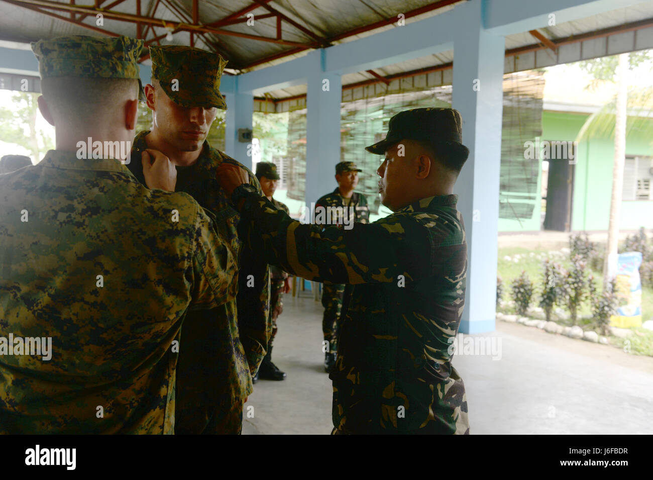 Philippine Army Capt. Win Love G. Bag-Ao, right, pins a new rank ...