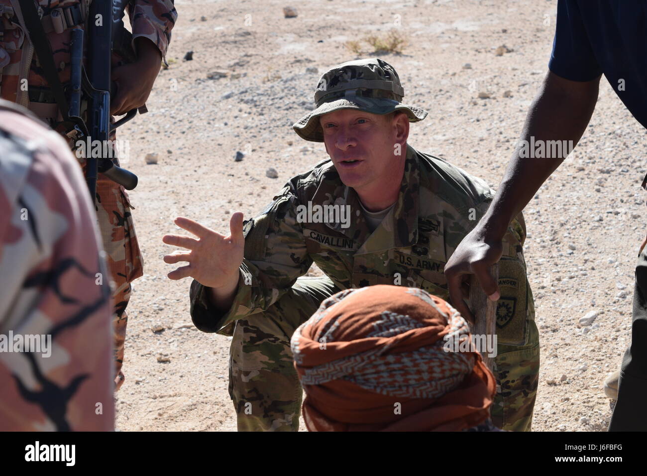 Soldiers from the Royal Army of Oman huddle around Lt. Col. Kent ...