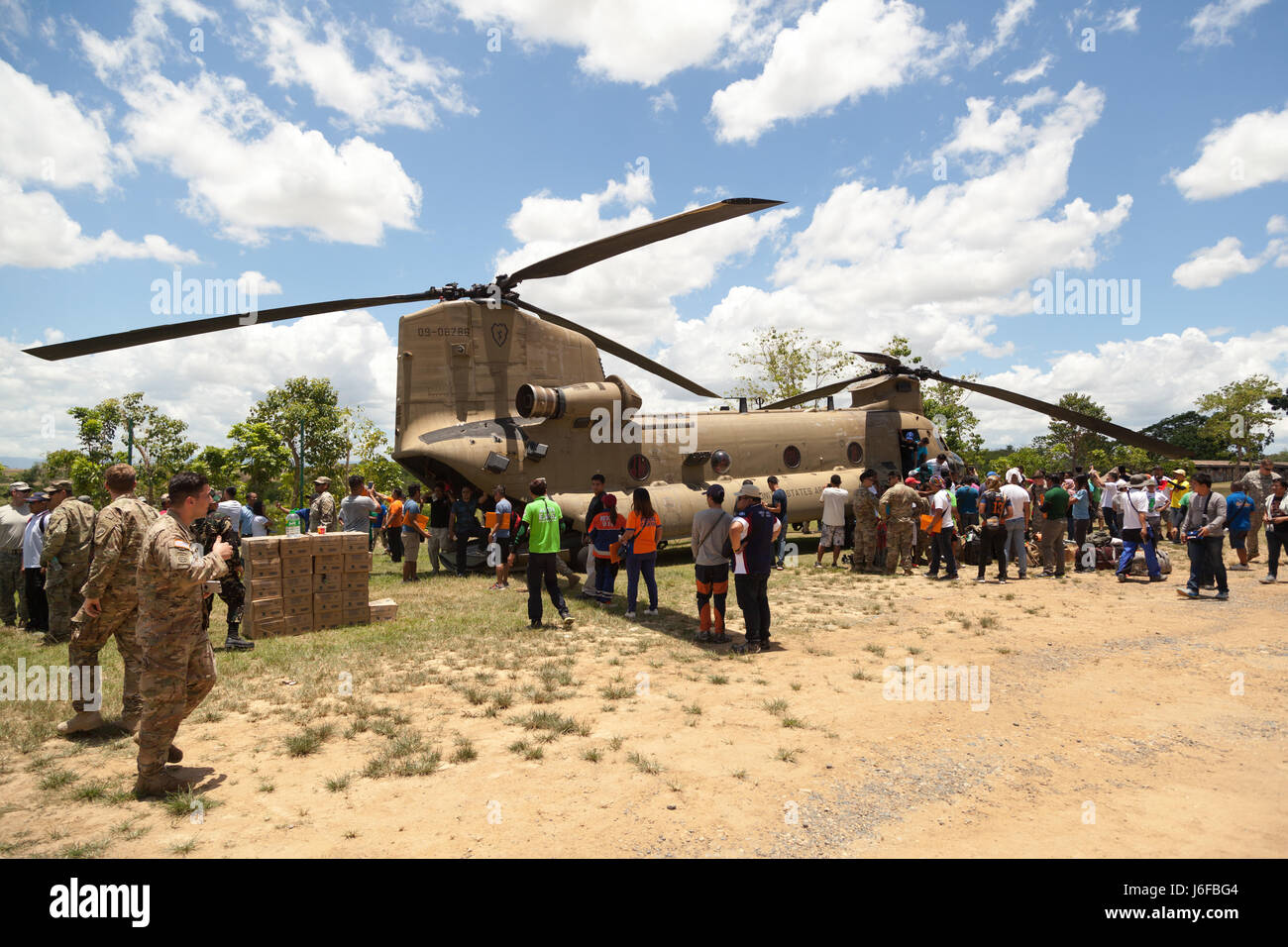 First responders walk around a U.S. Army CH-47 Chinook helicopter ...