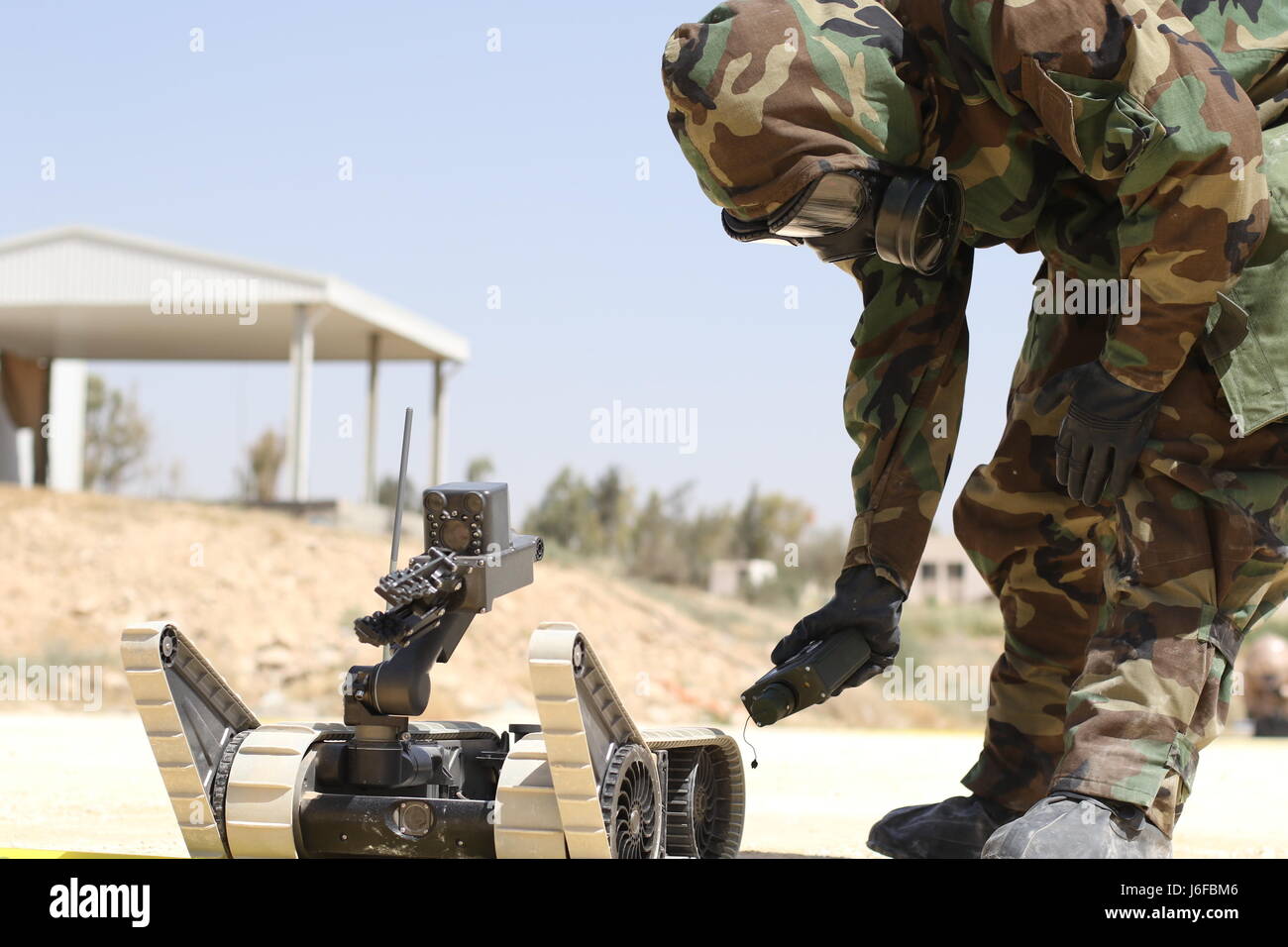 A Jordan Armed Forces soldier checks a recon robot for contamination ...
