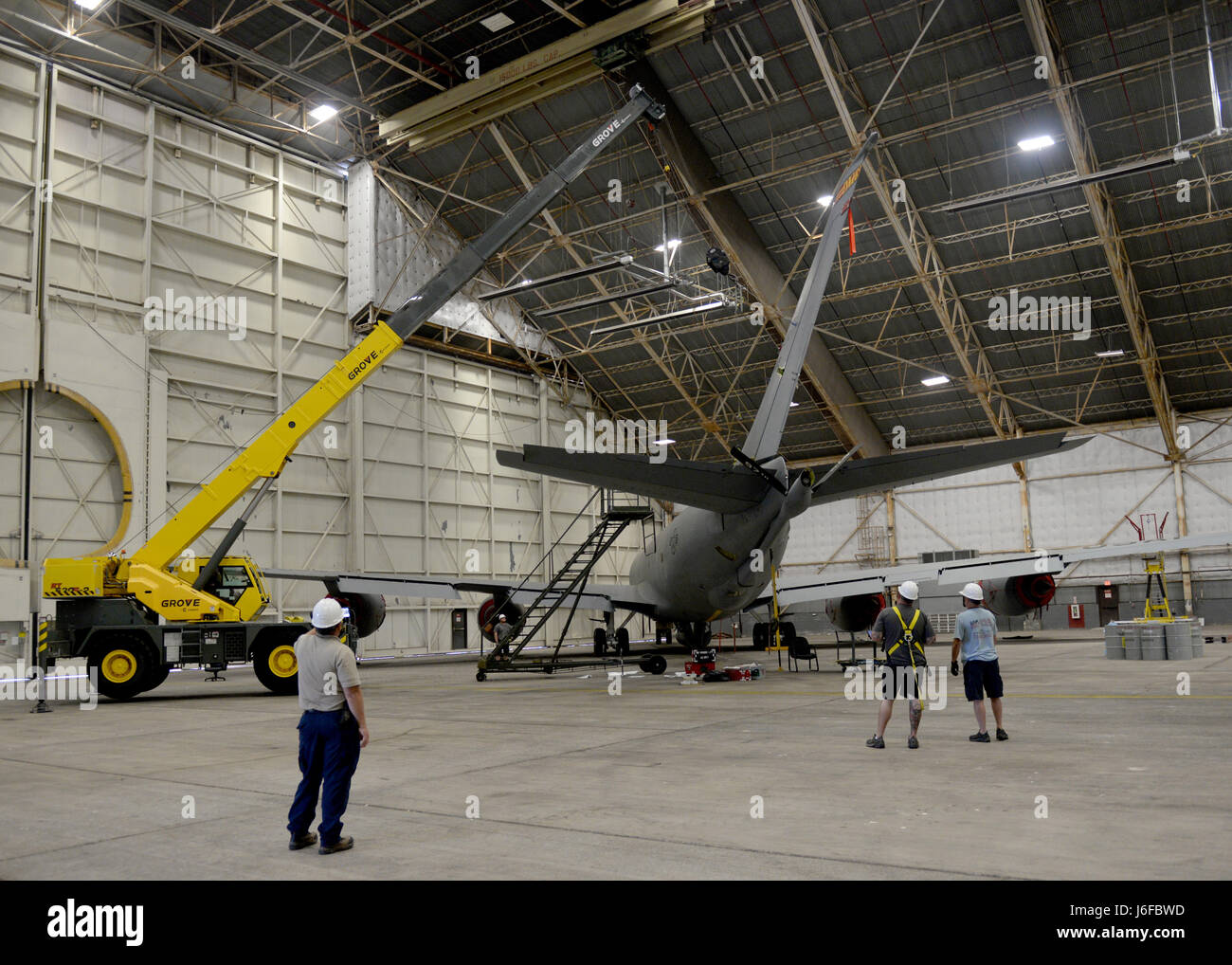 Members from the 97th Maintenance Directorate hoist a vertical fin of a ...