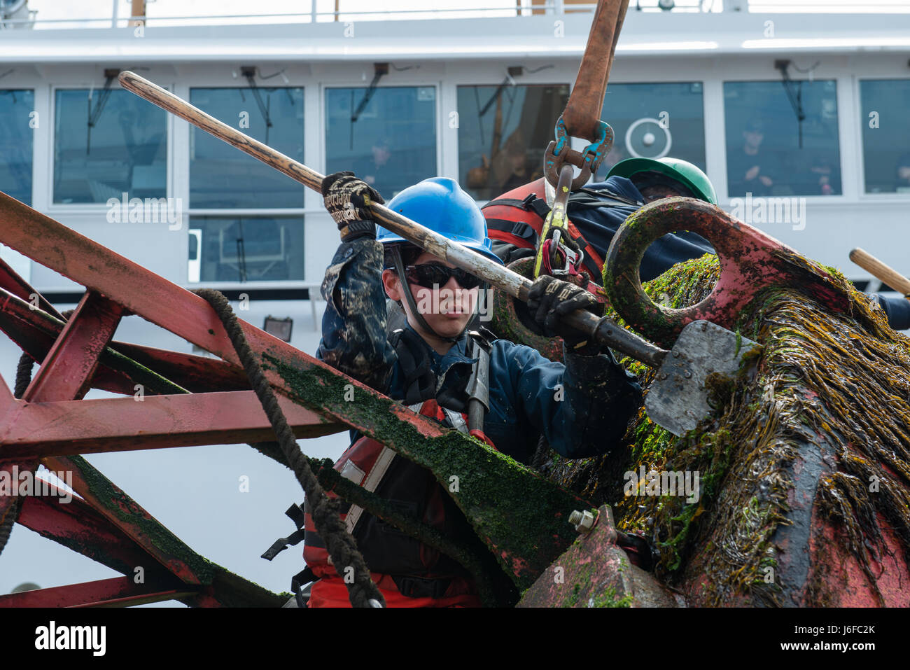 Coast Guard Cutter Oak crewmember, Seaman Samantha Schwind scrapes ...