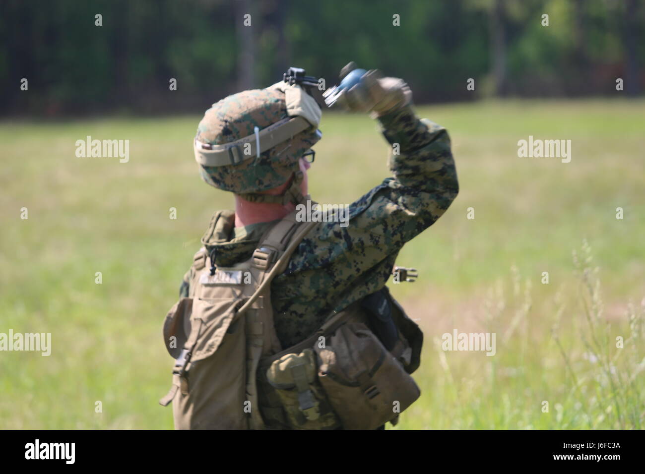 Marine Pfc. Aaron Healey launches an M69 training hand grenade during a ...