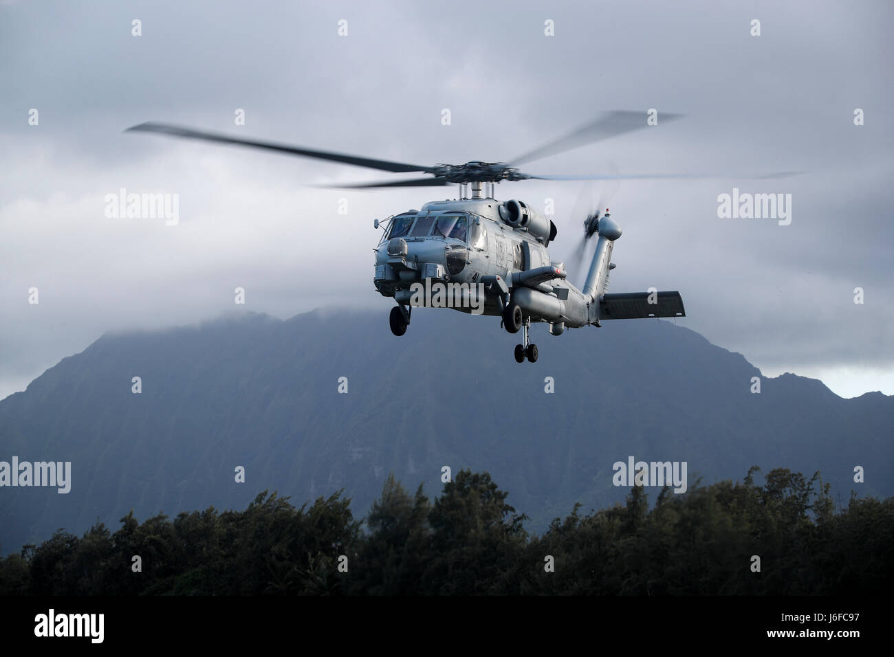 A U.S. Navy SH-60 Sea Hawk helicopter hovers over Landing Zone ...