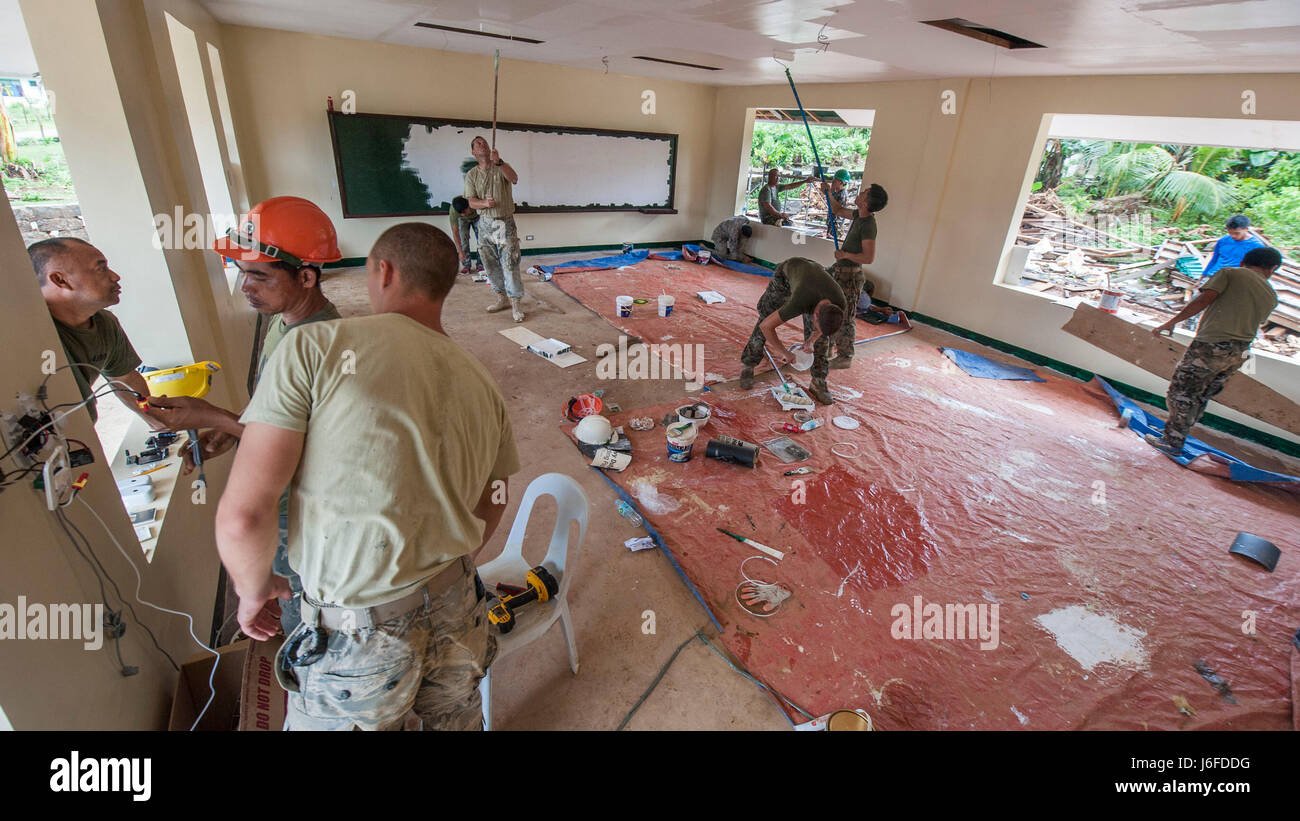 Philippine and U.S. service members clean up a multi-purpose classroom ...