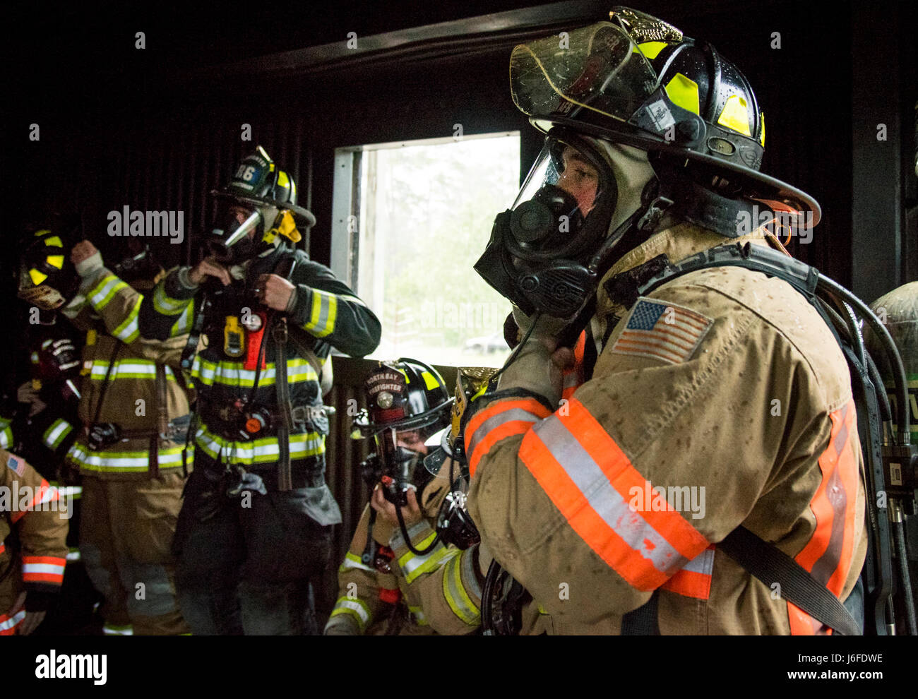 Firefighters put on their protective equipment prior to a live burn ...